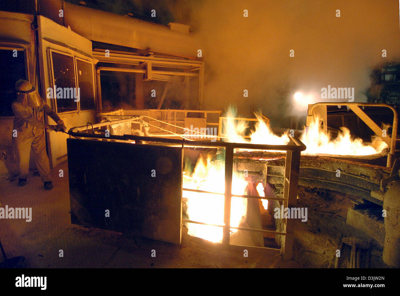 (dpa) - A worker uses a long pole to test liquid copper on the factory ...