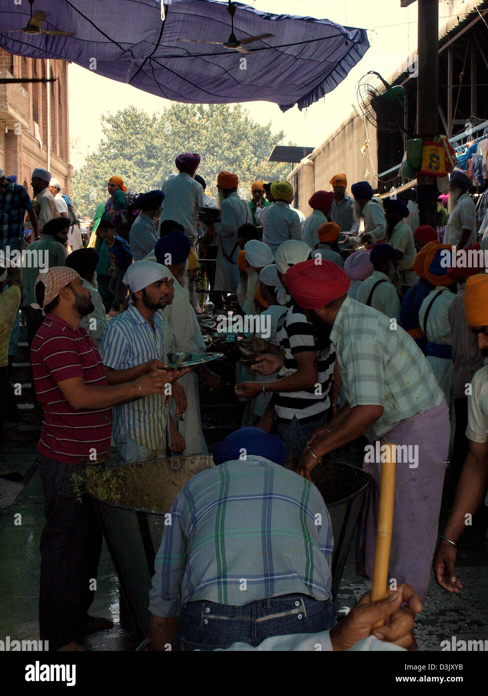 Sikhs, tourists and pilgrims at the free kitchen langar at the Golden ...