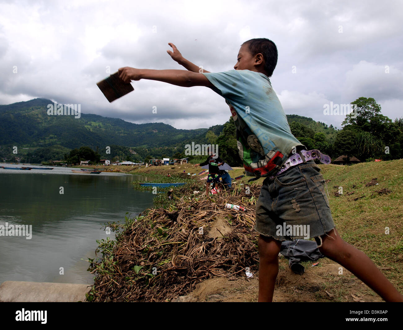 Nepali boy fishing, Phewa Lake (Phewa Tal) in Pokhara, Nepal Stock ...