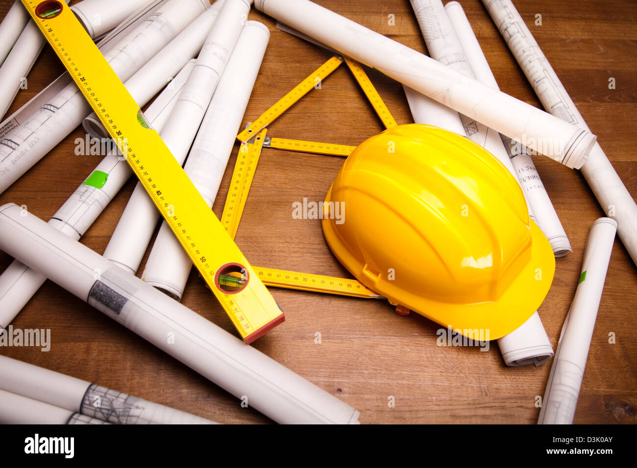 Architecture plans and yellow hard hat Stock Photo - Alamy