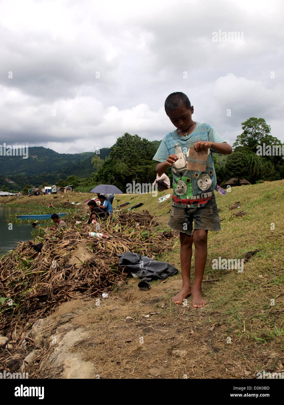 Nepali boy fishing, Phewa Lake (Phewa Tal) in Pokhara, Nepal Stock ...
