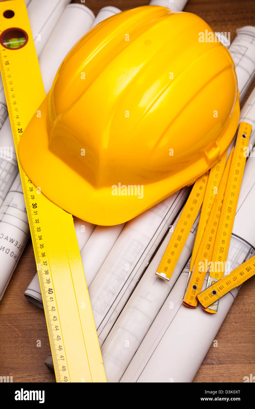 Architecture plans and yellow hard hat Stock Photo - Alamy
