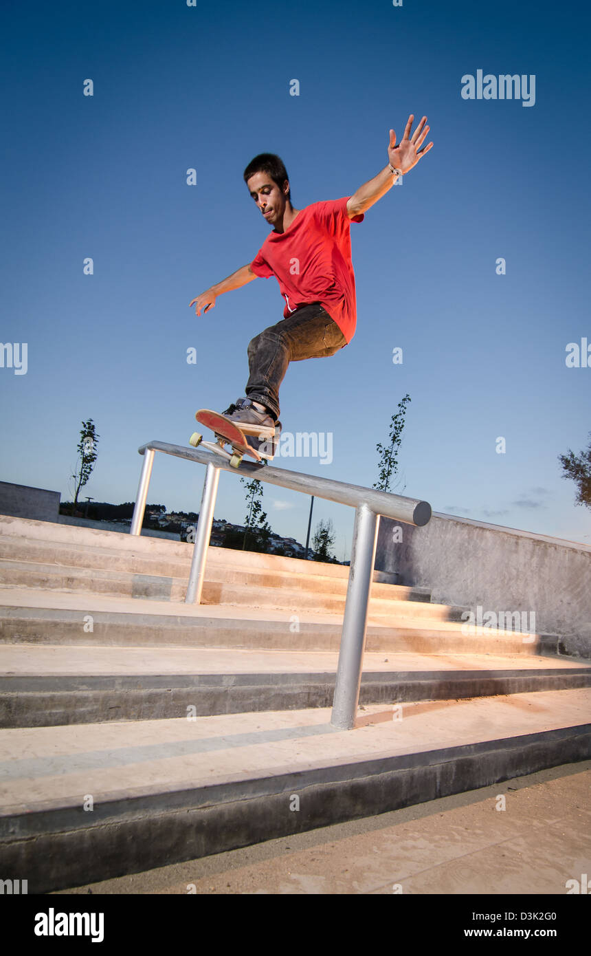 Skateboarder doing a FS Feeble on rail Stock Photo - Alamy