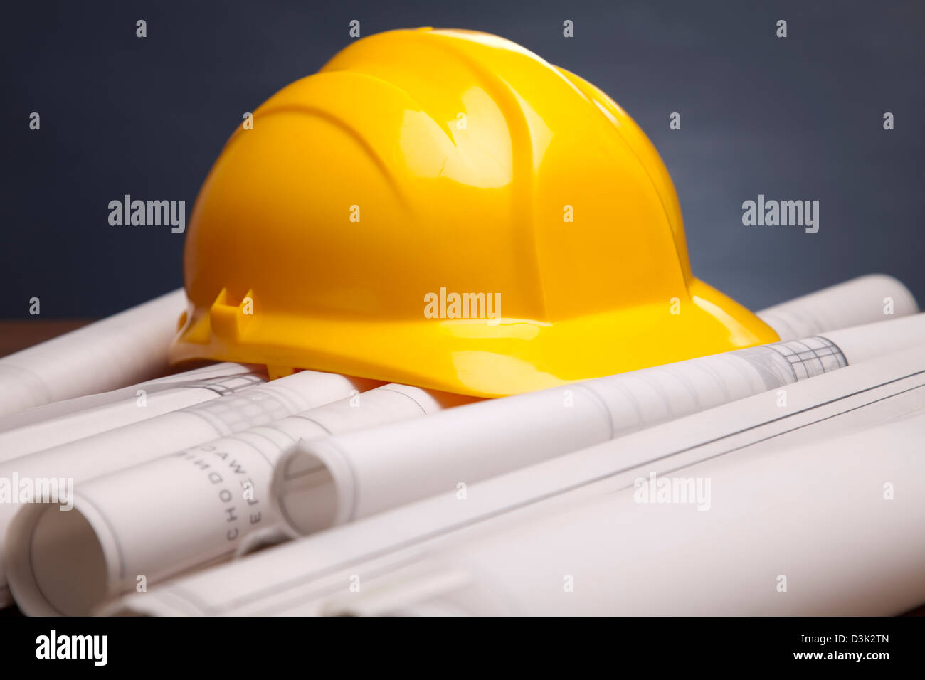 Architecture plans and yellow hard hat Stock Photo - Alamy