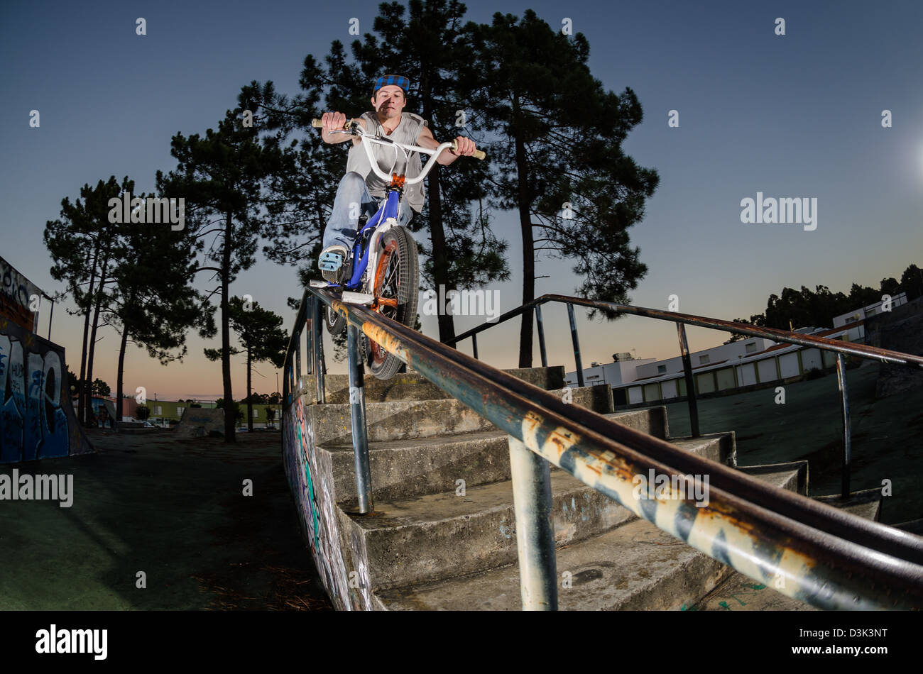 Biker doing peg grind down the hand rail over the stairs Stock Photo ...
