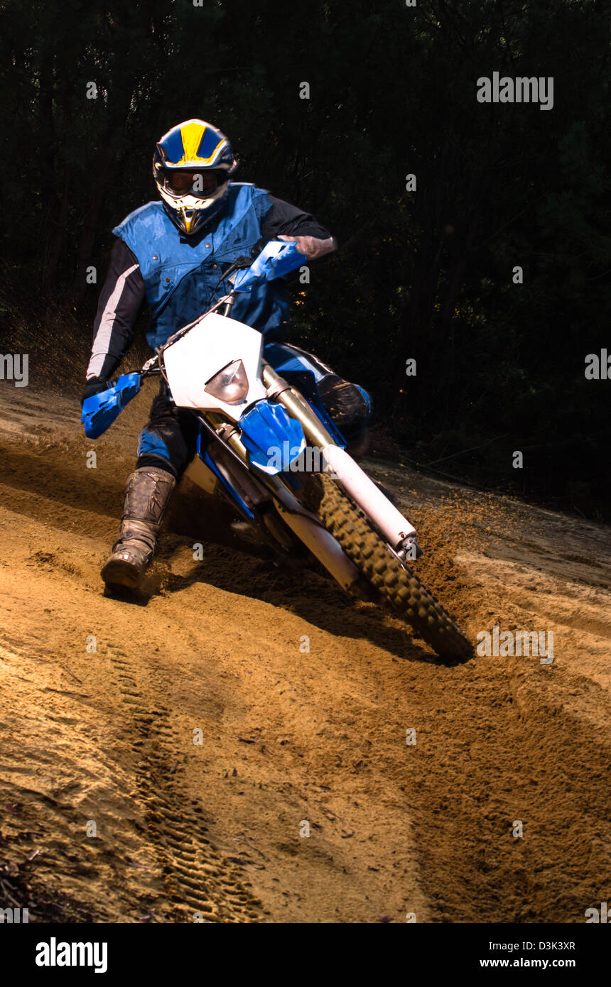 Enduro bike rider on action. Turn on sand terrain Stock Photo - Alamy