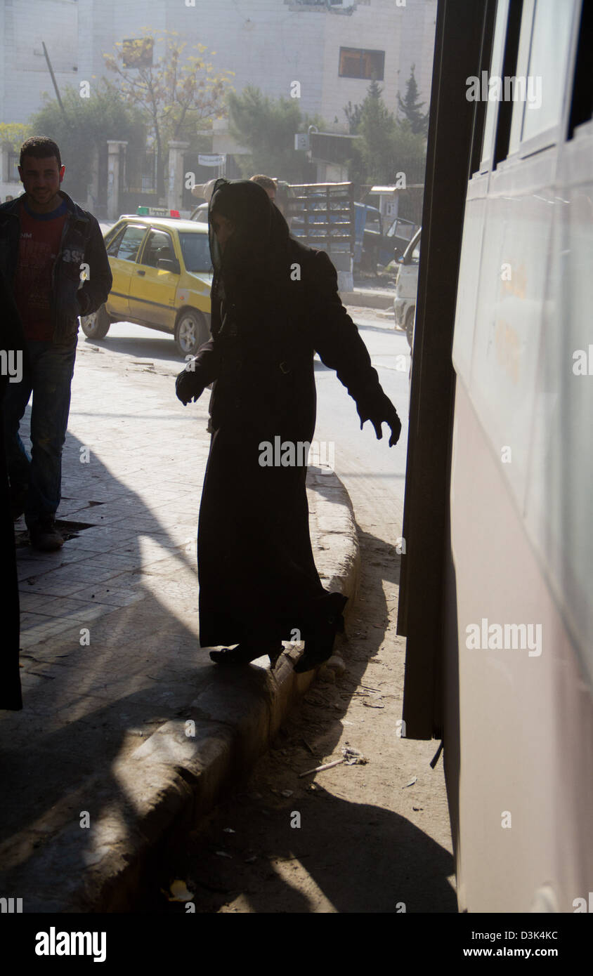 Aleppo, Syria: People ride a public bus. Services are limited with only ...