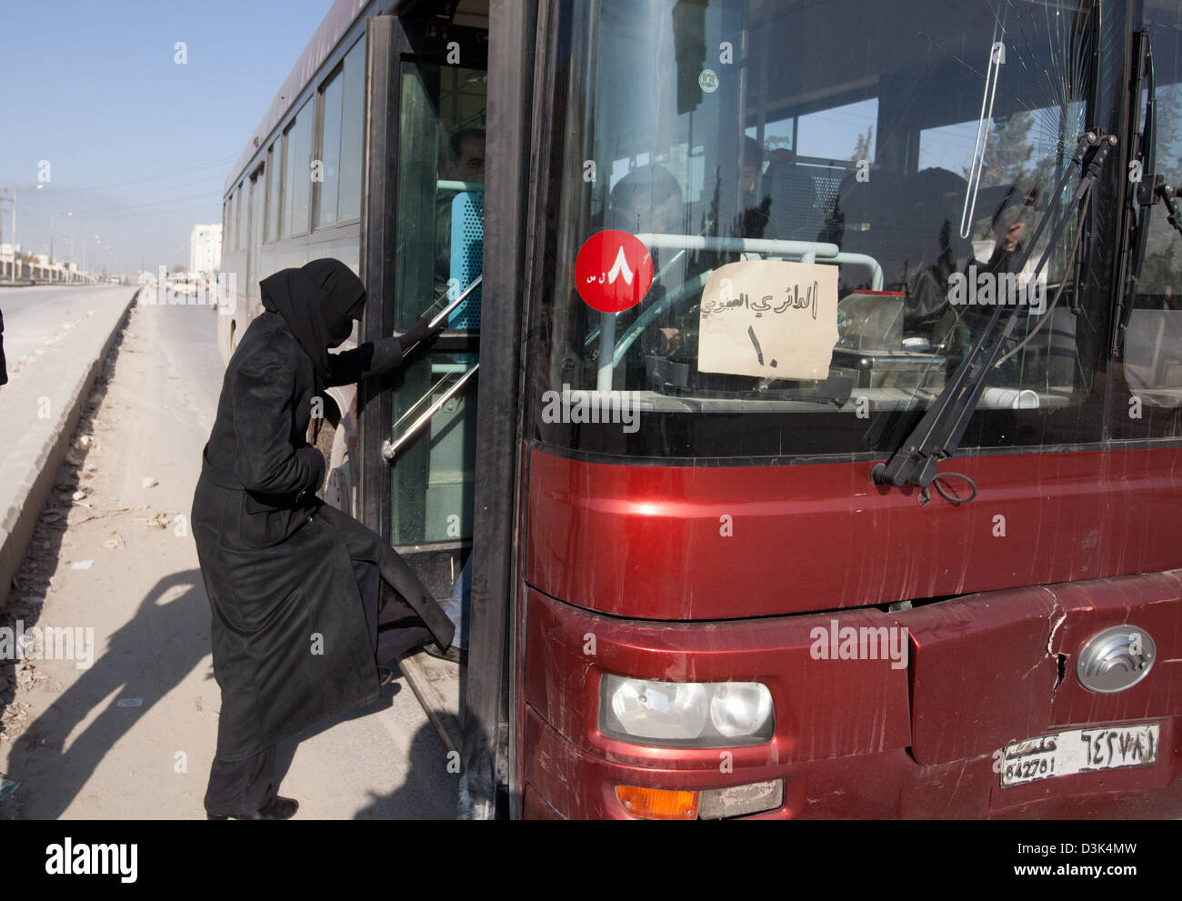 Aleppo, Syria: People ride a public bus. Services are limited with only ...