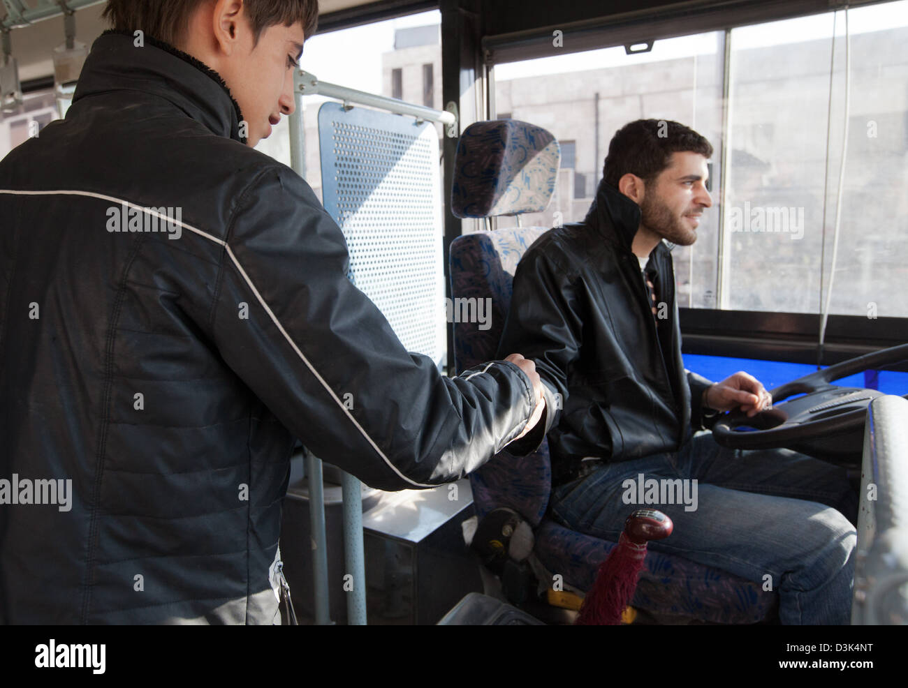 Aleppo, Syria: People ride a public bus. Services are limited with only ...