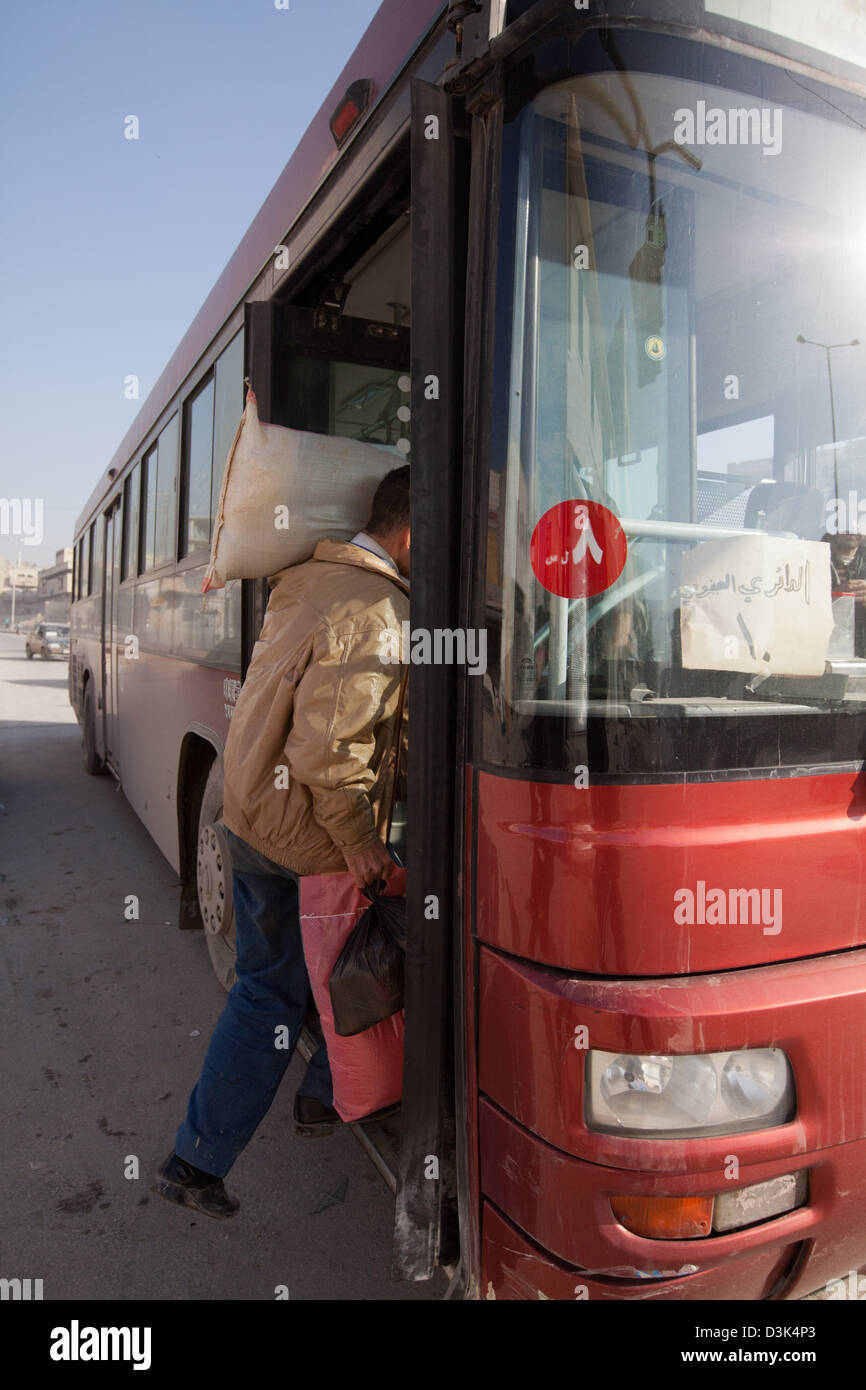 Aleppo, Syria: People ride a public bus. Services are limited with only ...