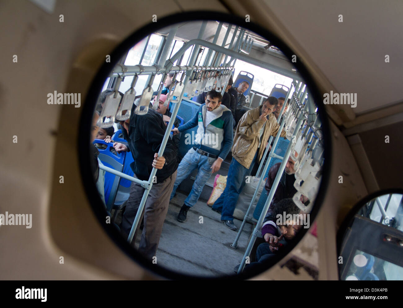 Aleppo, Syria: People ride a public bus. Services are limited with only ...