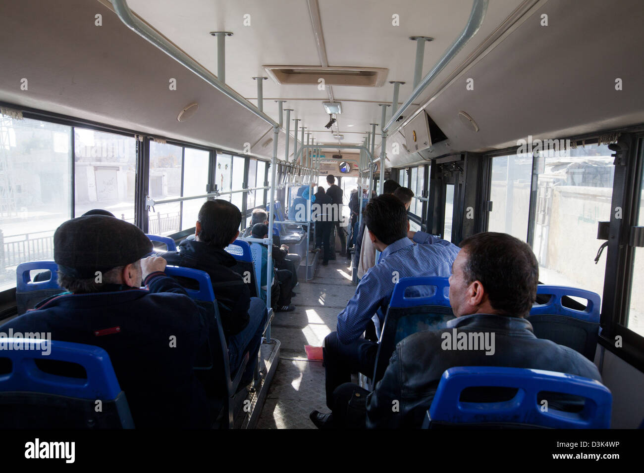 Aleppo, Syria: People ride a public bus. Services are limited with only ...