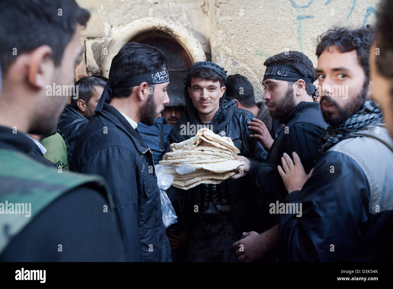 Aleppo, Syria: People wait in line for bread at a bakery. Huge bread ...