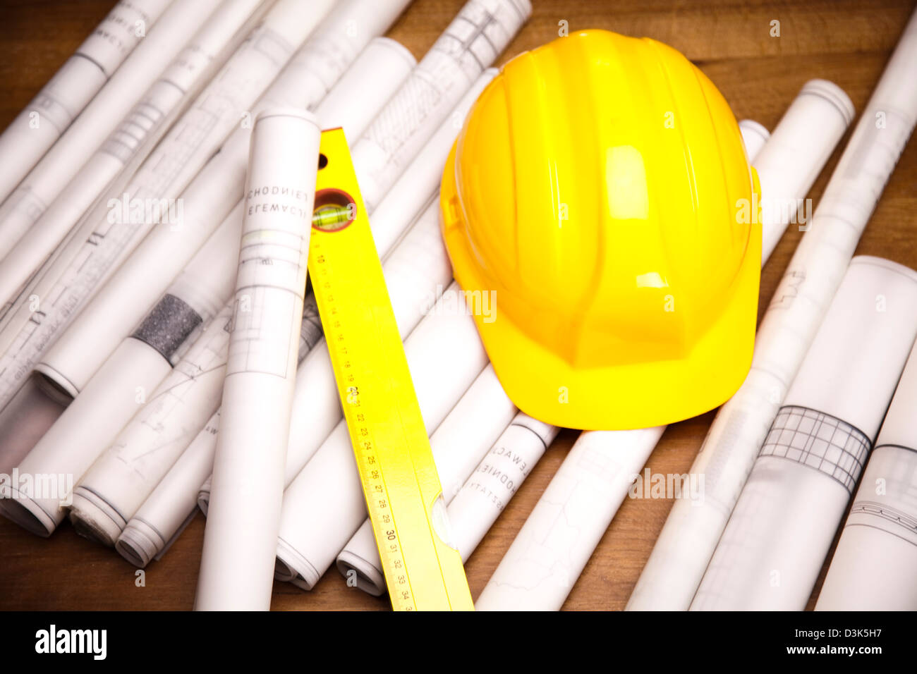 Construction Plans and yellow hard hat Stock Photo - Alamy
