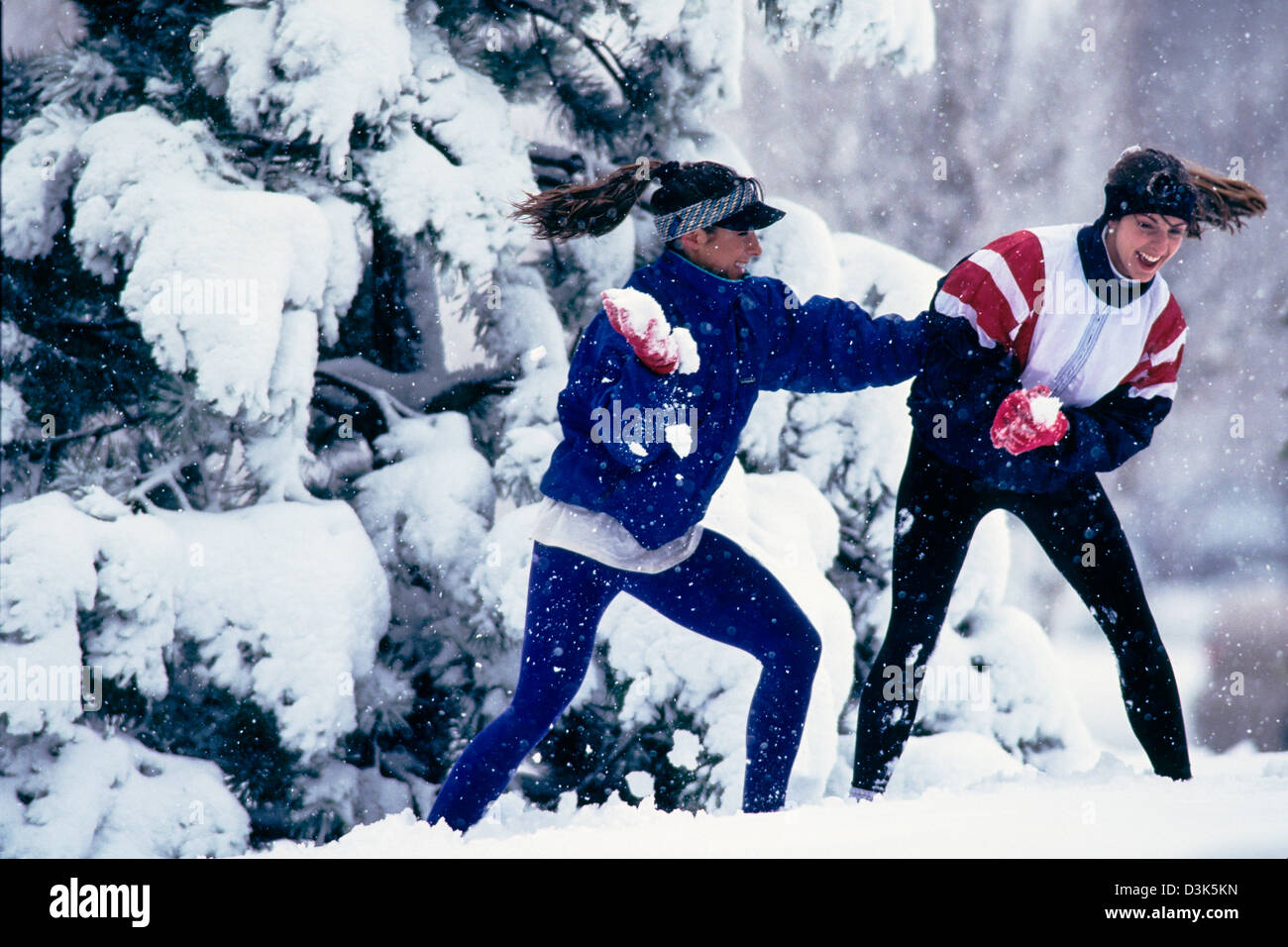 Two women during a snow ball fight Stock Photo - Alamy