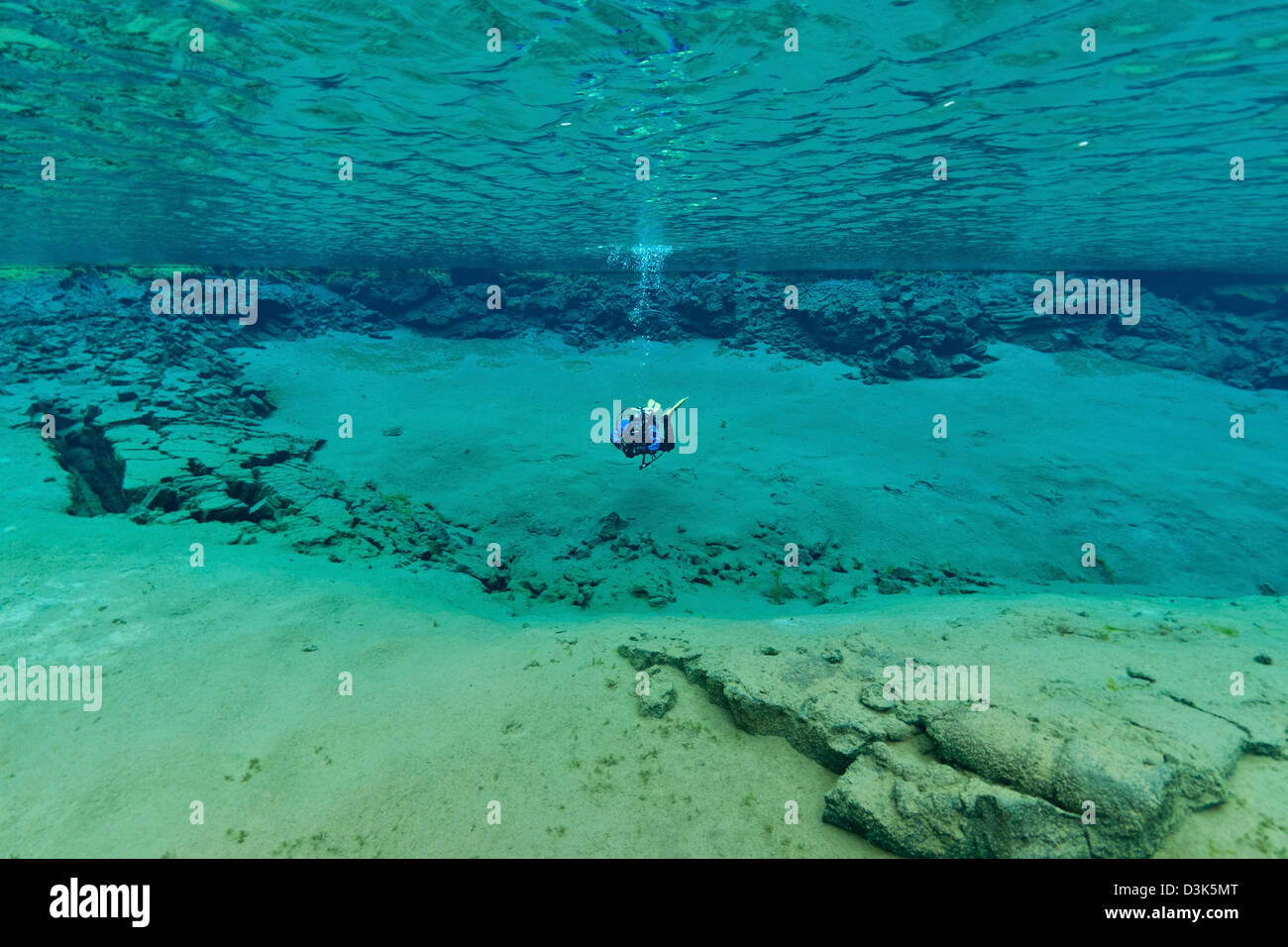 Diver in ultra clear water at The Silfra Lagoon, Iceland Stock Photo ...