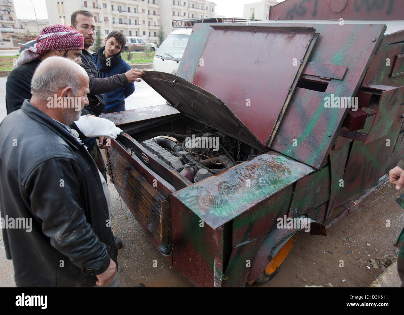 Free Syrian Army fighters inspect a homemade tank. It was designed for ...