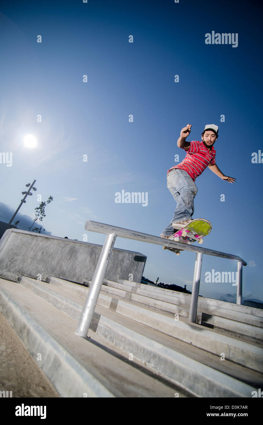 Skateboarder on a slide at the local skatepark Stock Photo - Alamy