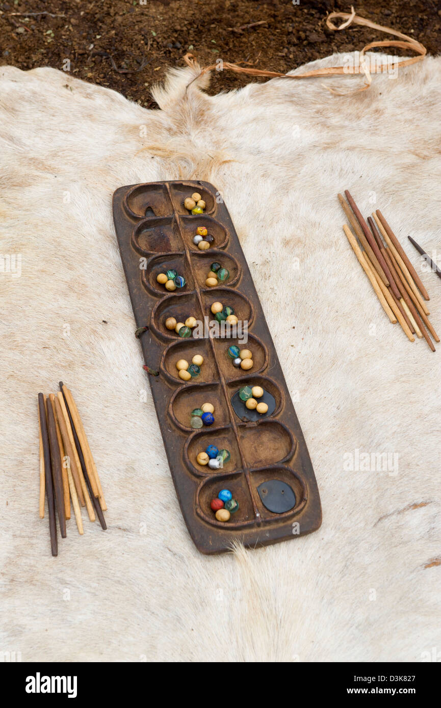 Enkeshui board, mankala game played by the Maasai, Selenkay Conservancy ...