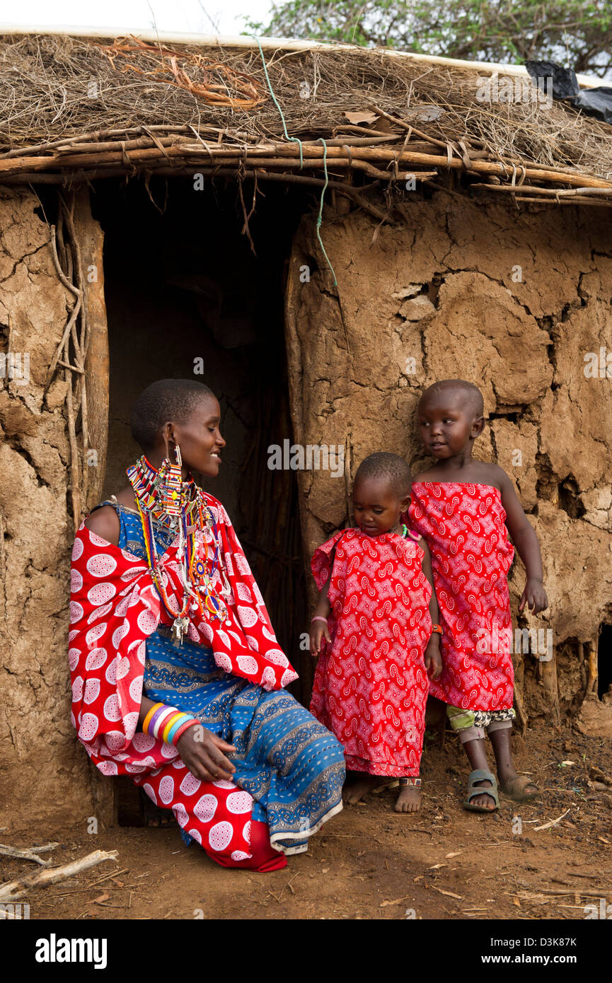 Maasai woman and children at her hut in the manyatta, Selenkay ...