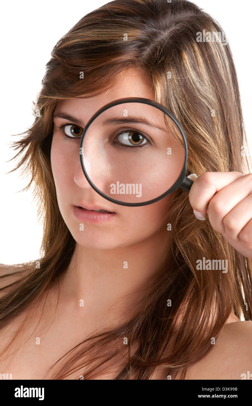 Woman looking trough a magnifying glass, isolated in a white background ...