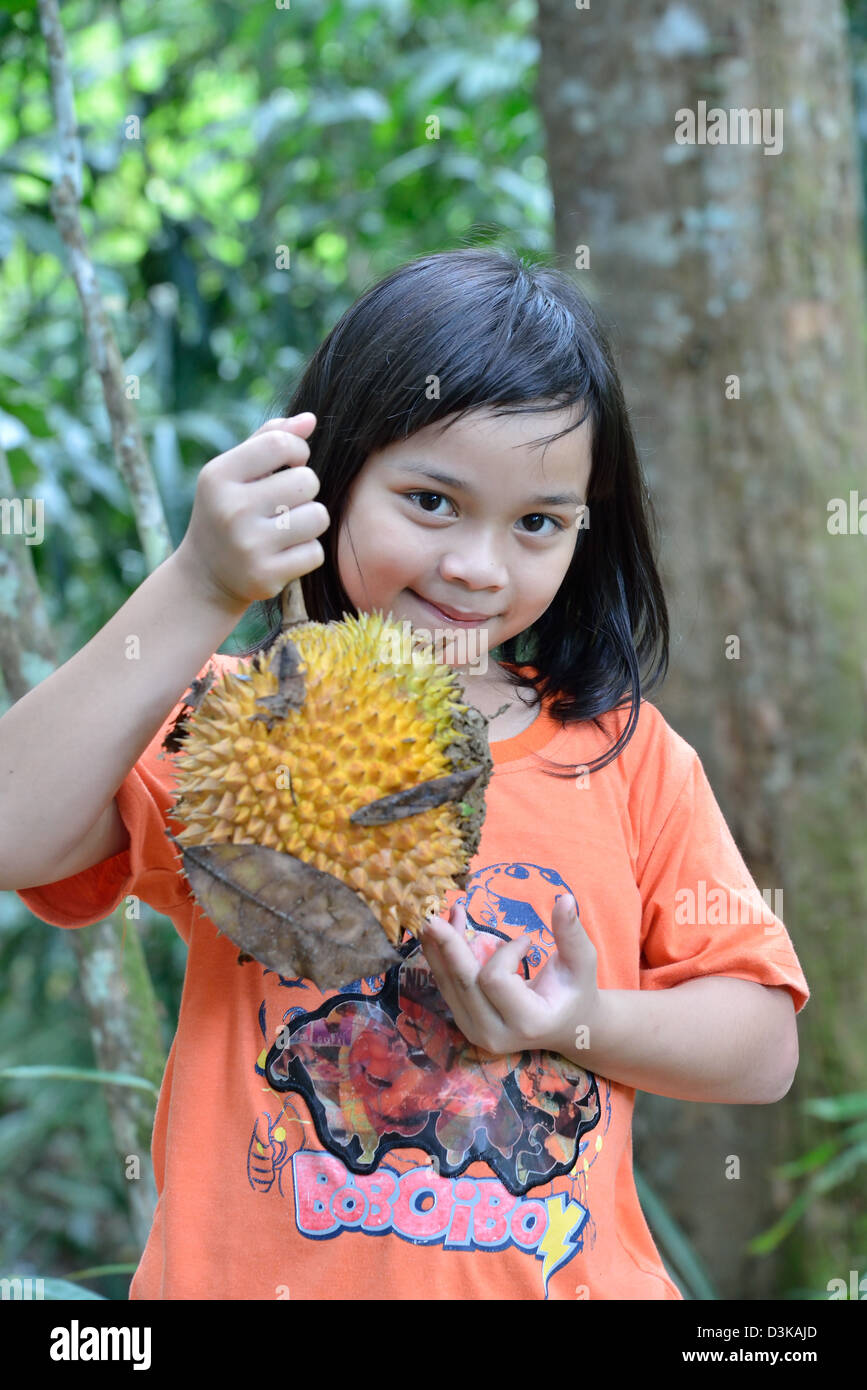 Bidayuh girl happy to find a durian fruit Stock Photo - Alamy