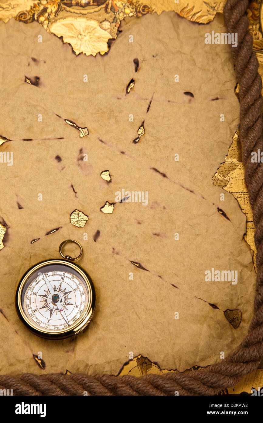 Old style compass and paper background Stock Photo - Alamy