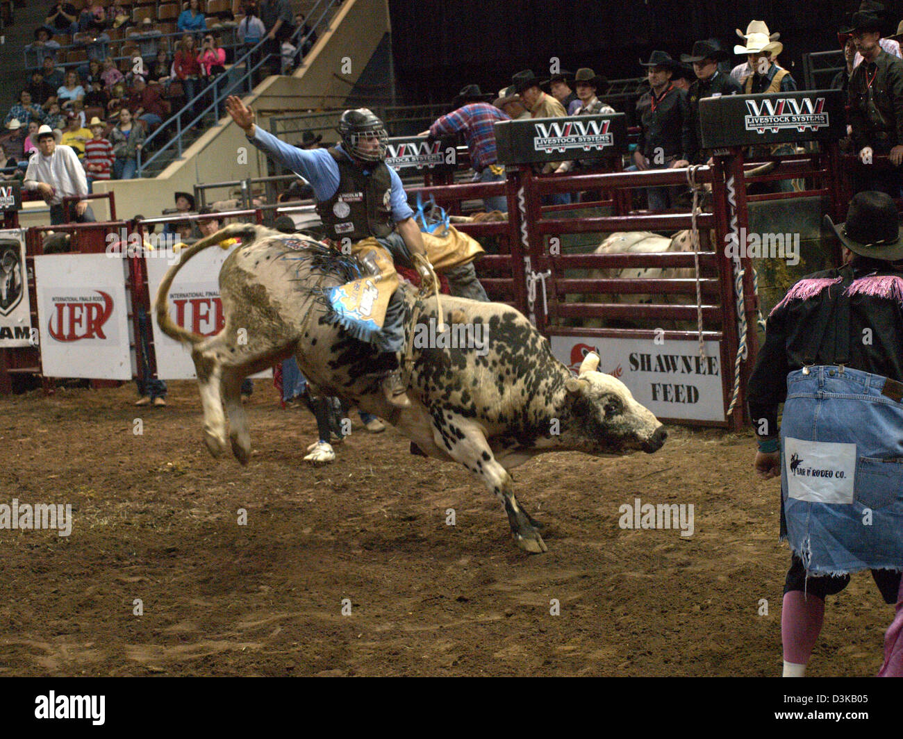 Cowboy riding bucking bull during the National Finals Rodeo in Oklahoma ...