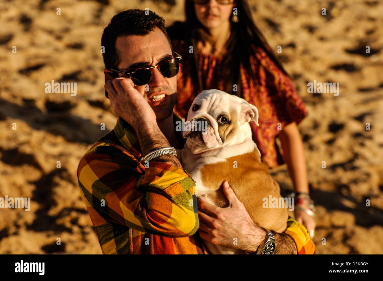 A man carrying his cute dog Stock Photo - Alamy
