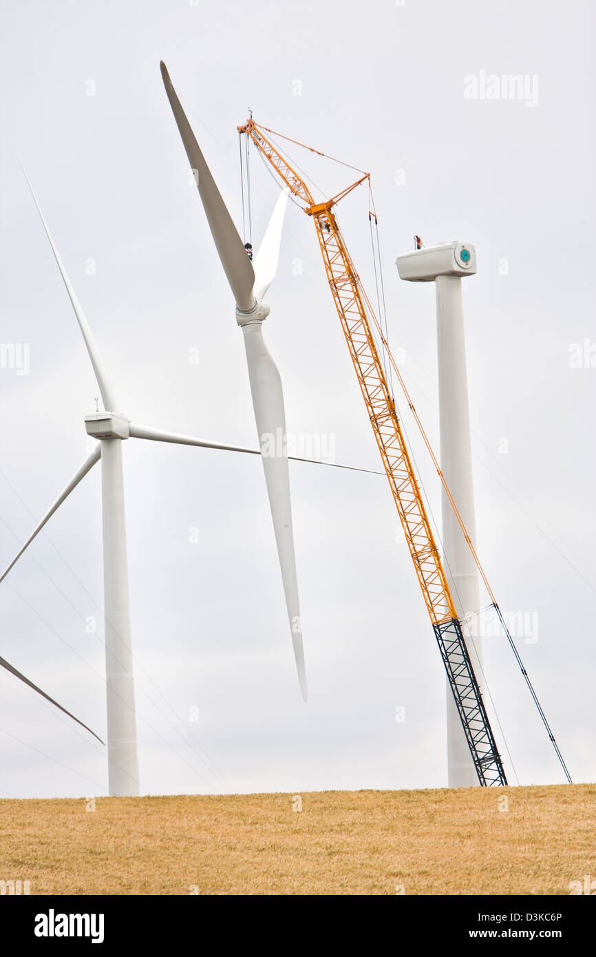 Wind farm, crane raising propeller to be attached to generator Stock ...