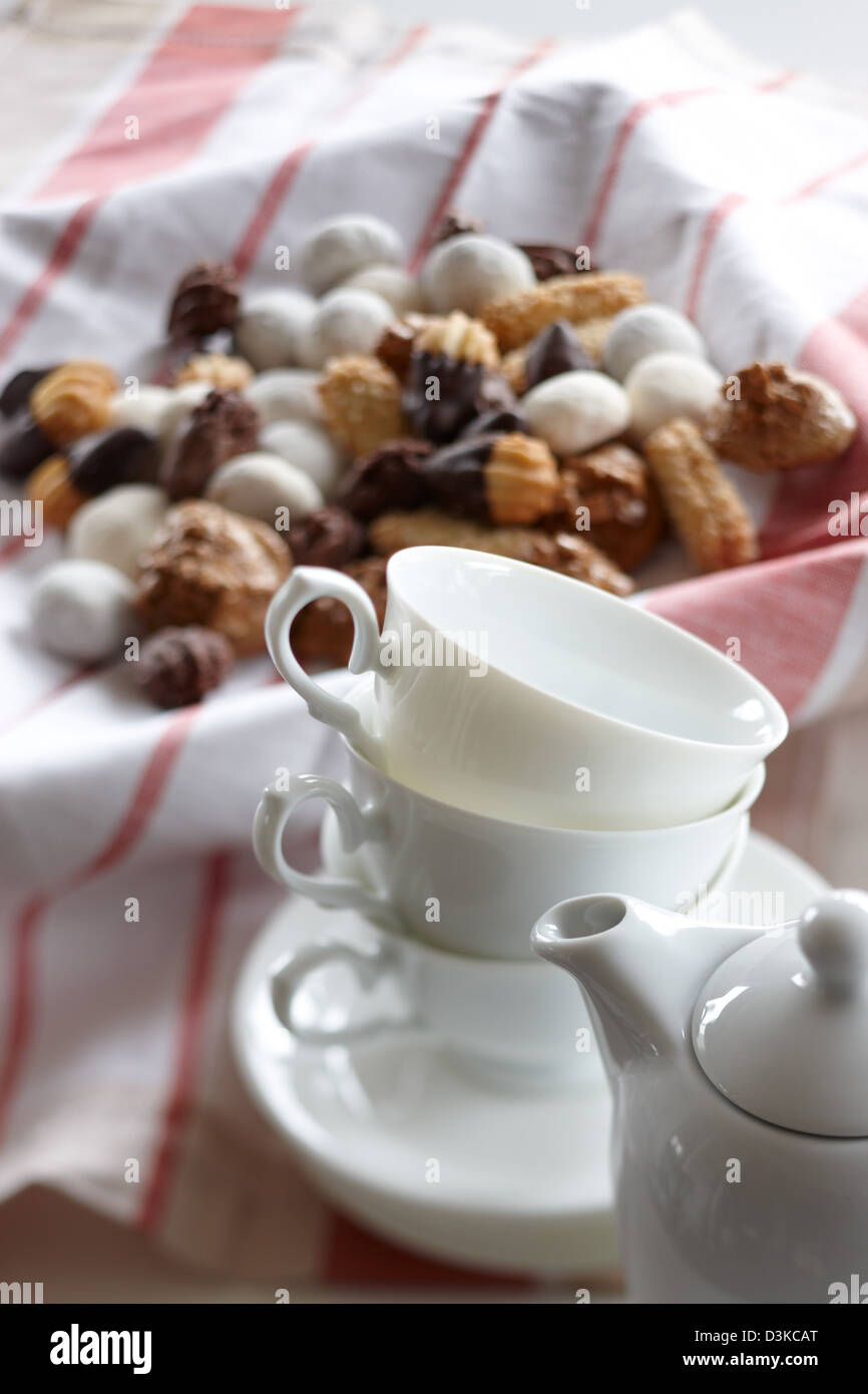 Tea cups and assorted pastry Stock Photo - Alamy
