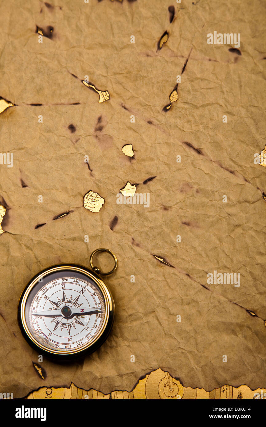 Old style compass and paper background Stock Photo - Alamy