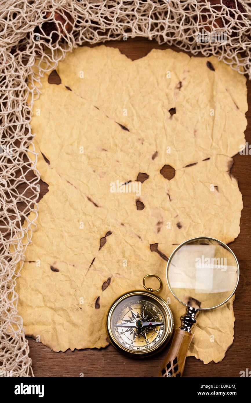 Old style compass and paper background Stock Photo - Alamy