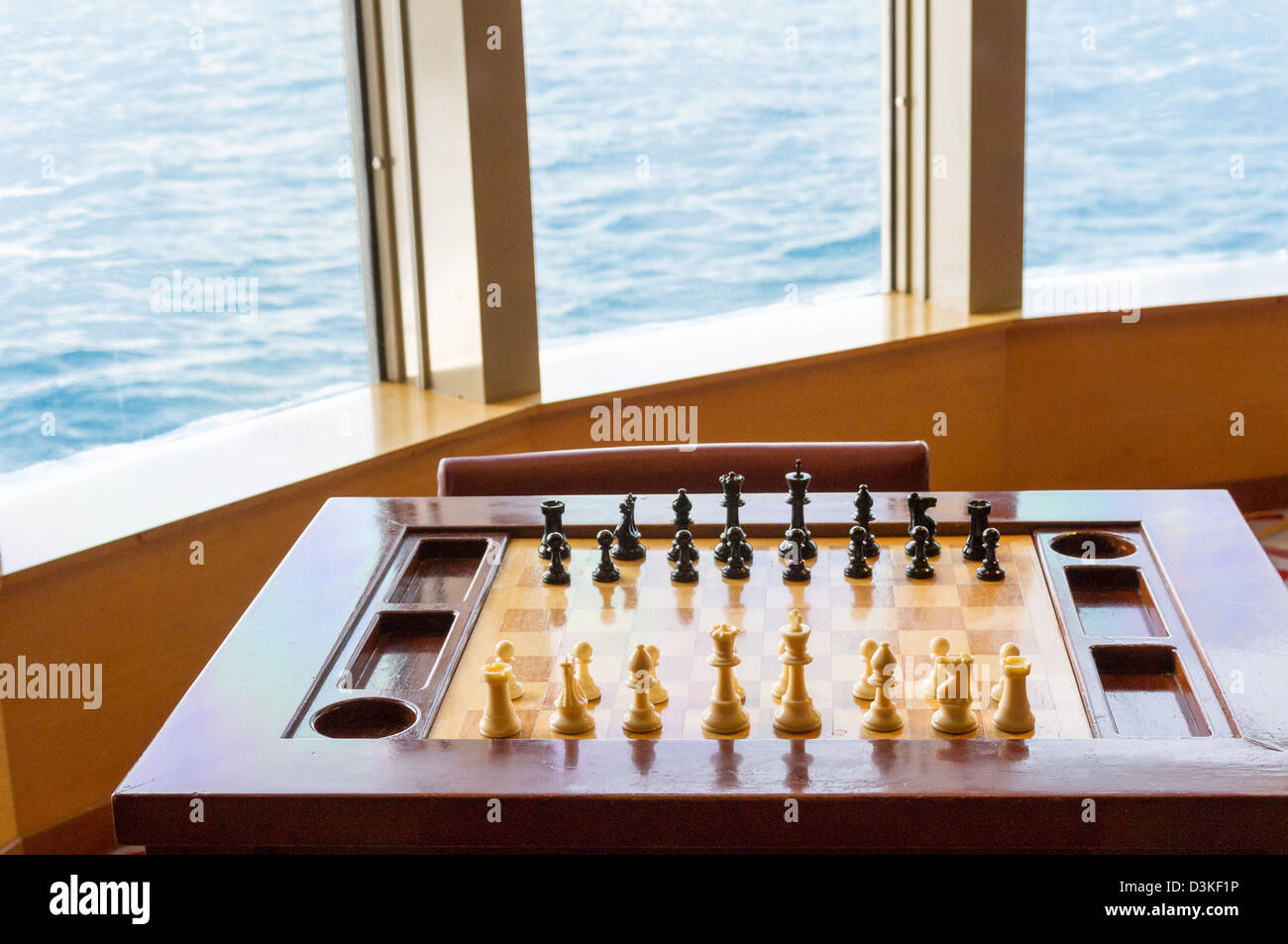 A chess set waiting in the card room of a cruise ship on the open sea ...