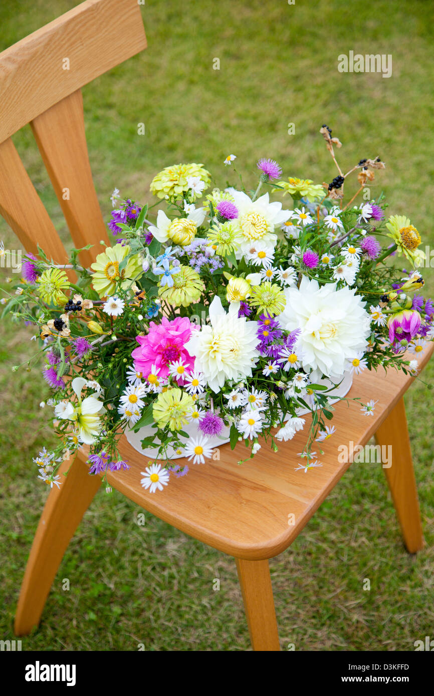 Flower bouquet on wooden chair Stock Photo - Alamy