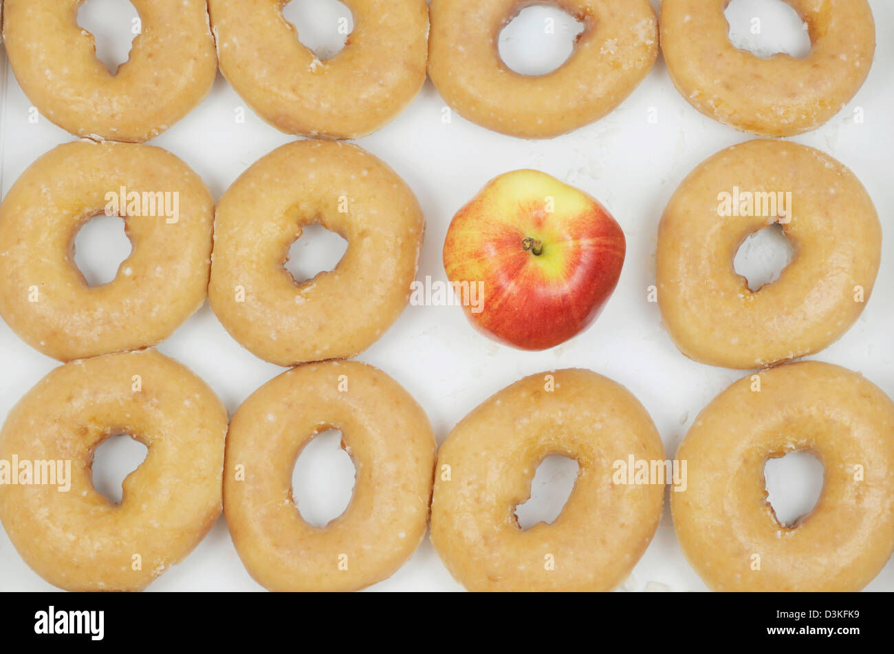 Eleven donuts pictured with an apple replacing what would have made a ...