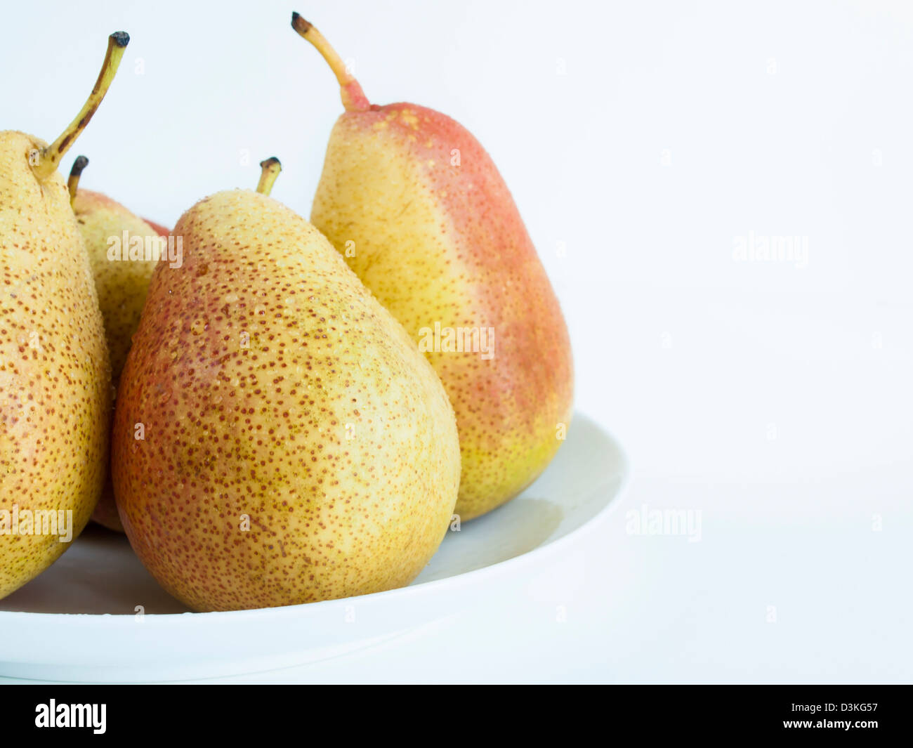 Ripe pear on white background. The cultivation of the pear in cool ...