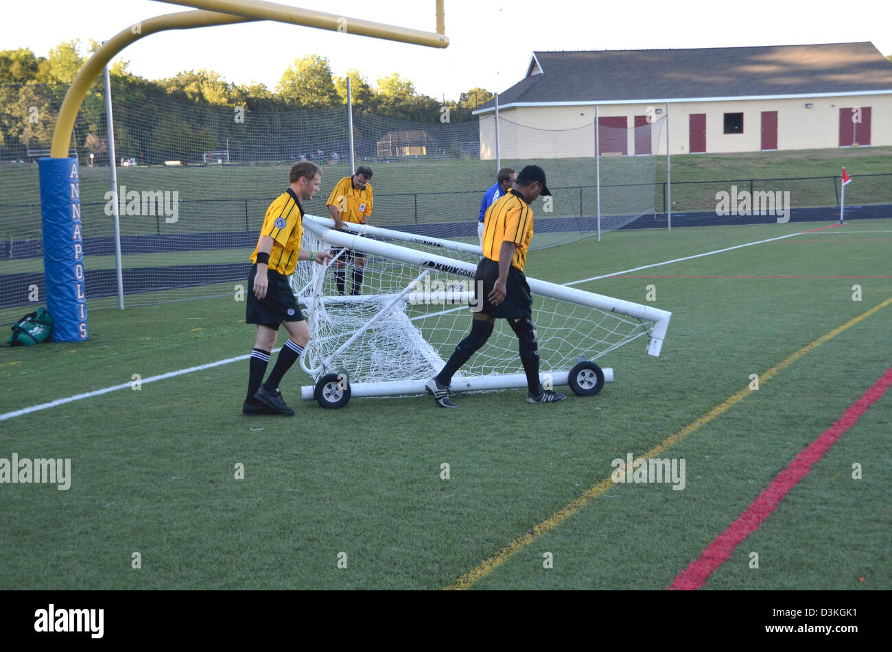 Officials remove a broken net during a lacrosse game Stock Photo - Alamy