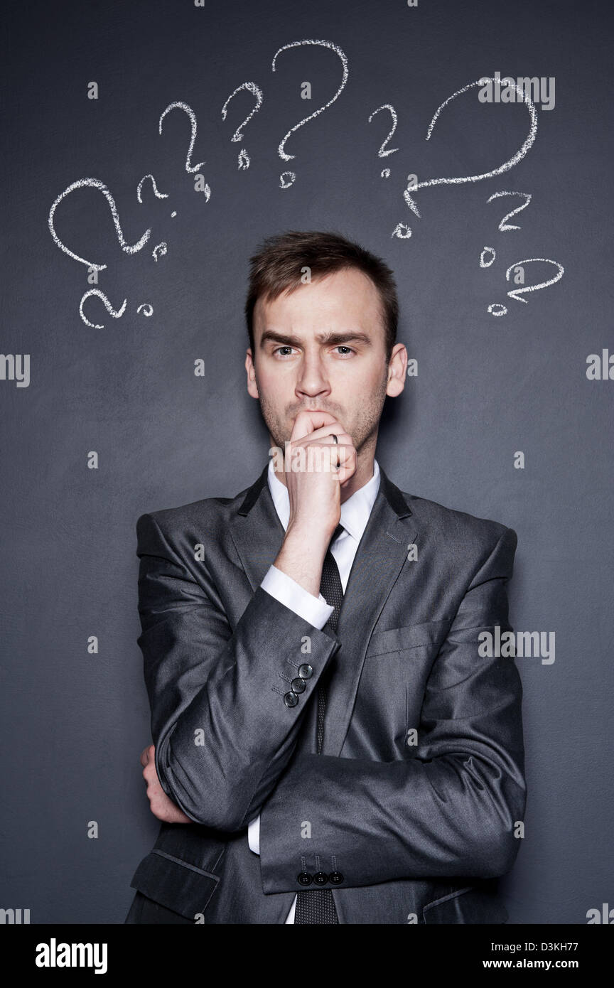 young handsome confused businessman with chalk drawn Stock Photo - Alamy