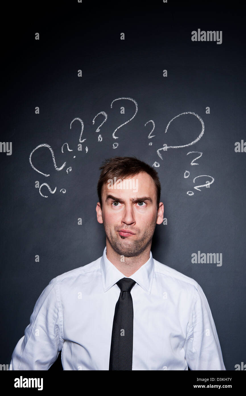 young handsome confused businessman with chalk drawn Stock Photo - Alamy