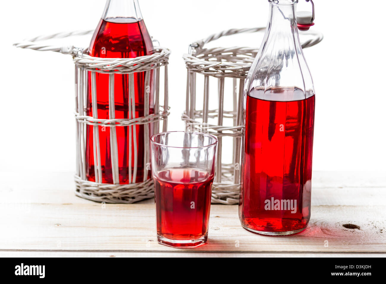Closeup of red juice in old bottles on white background Stock Photo - Alamy