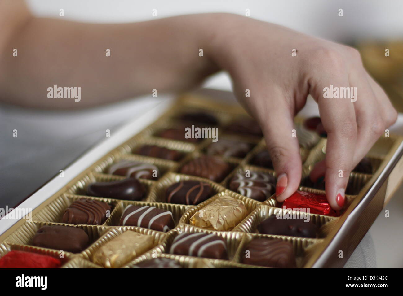 Chocolates hand hi-res stock photography and images - Alamy
