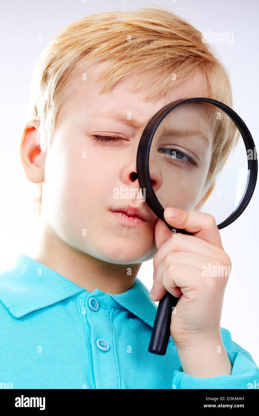 Portrait of a kid looking through magnifying glass Stock Photo - Alamy