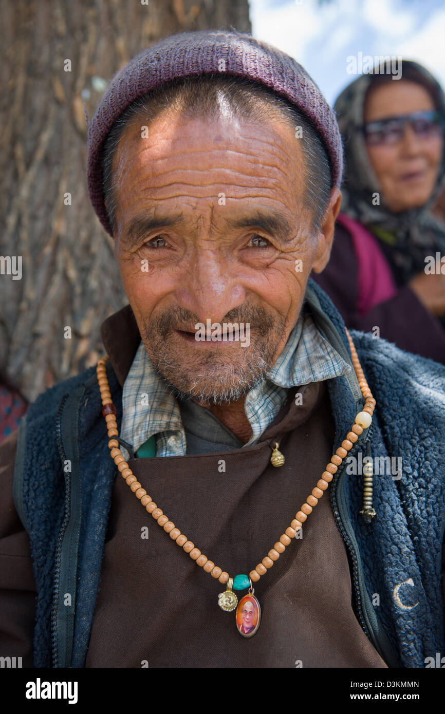 Old male Pilgrim with prayer beads at a festival at Soma Gompa, Leh ...