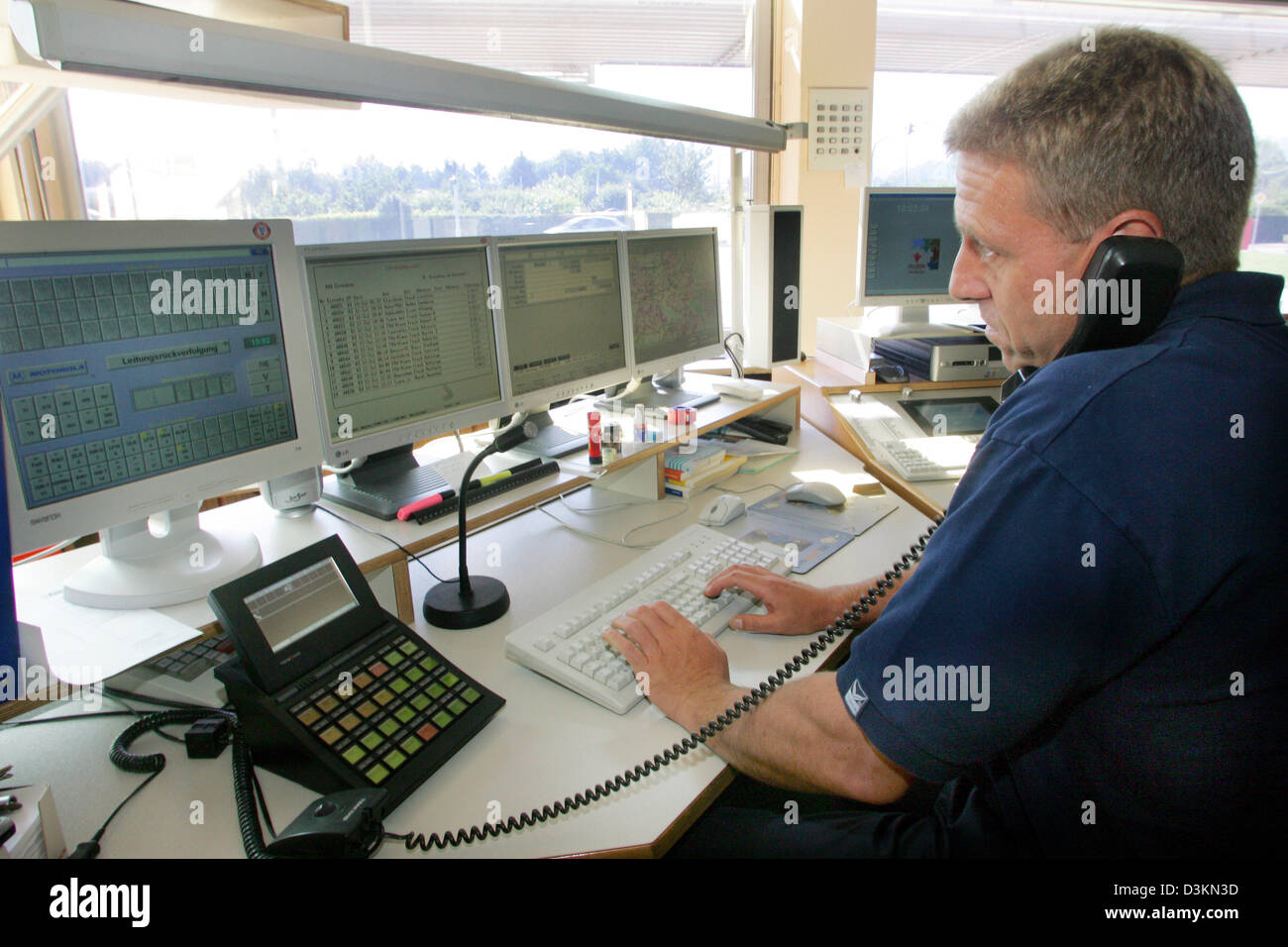 (dpa) - A firefighter receives an emergency phone call in the control ...