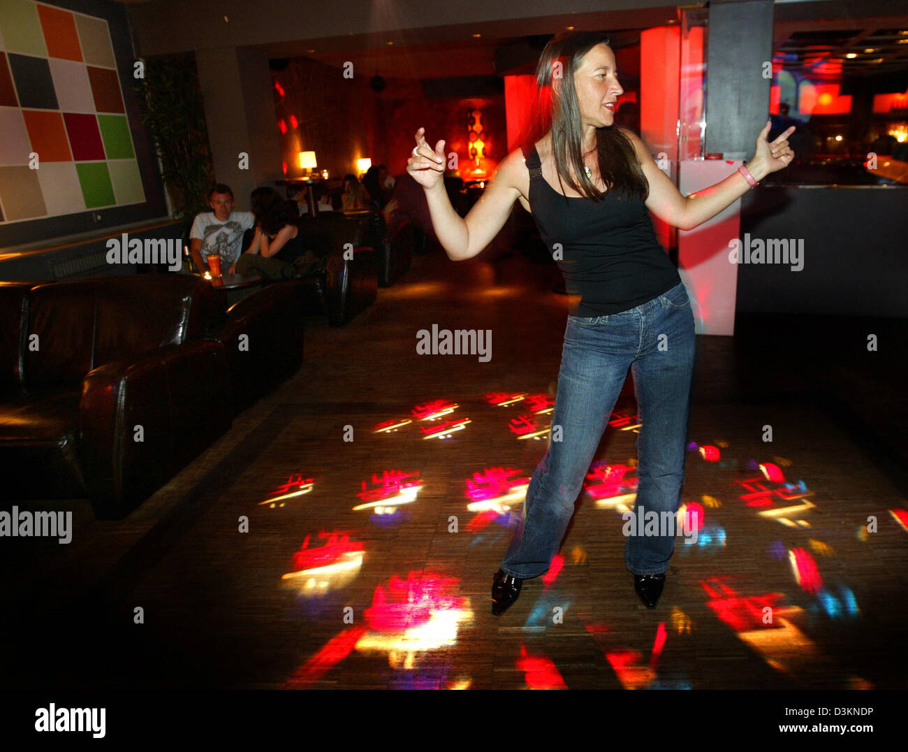 (dpa) - A young woman dances in a discotheque in Wuerzburg, Germany, 31 ...