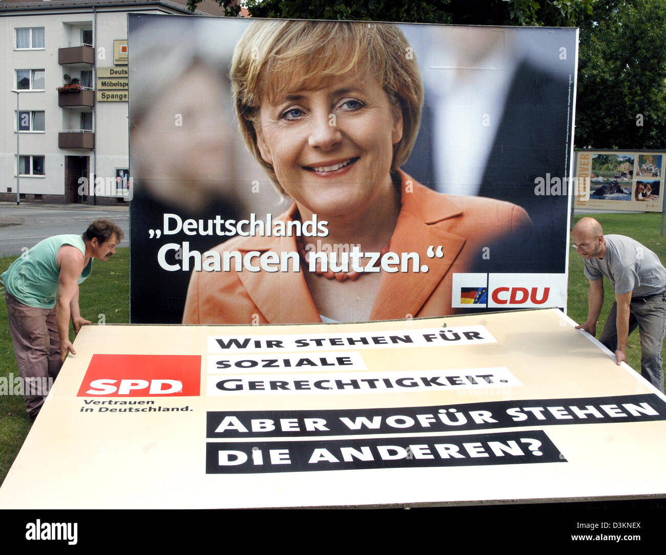 (dpa) - Staff members of an advertising company erect billboards of the ...