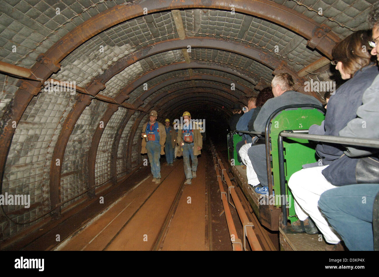 (dpa) - The picture shows a group of pitmen (L) passing visitors ...