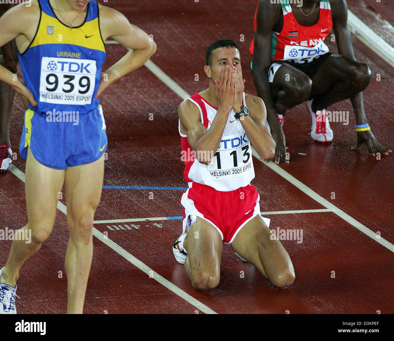 (dpa) - Rashid Ramzi from Bahrain (C) kneels on the tracks after ...