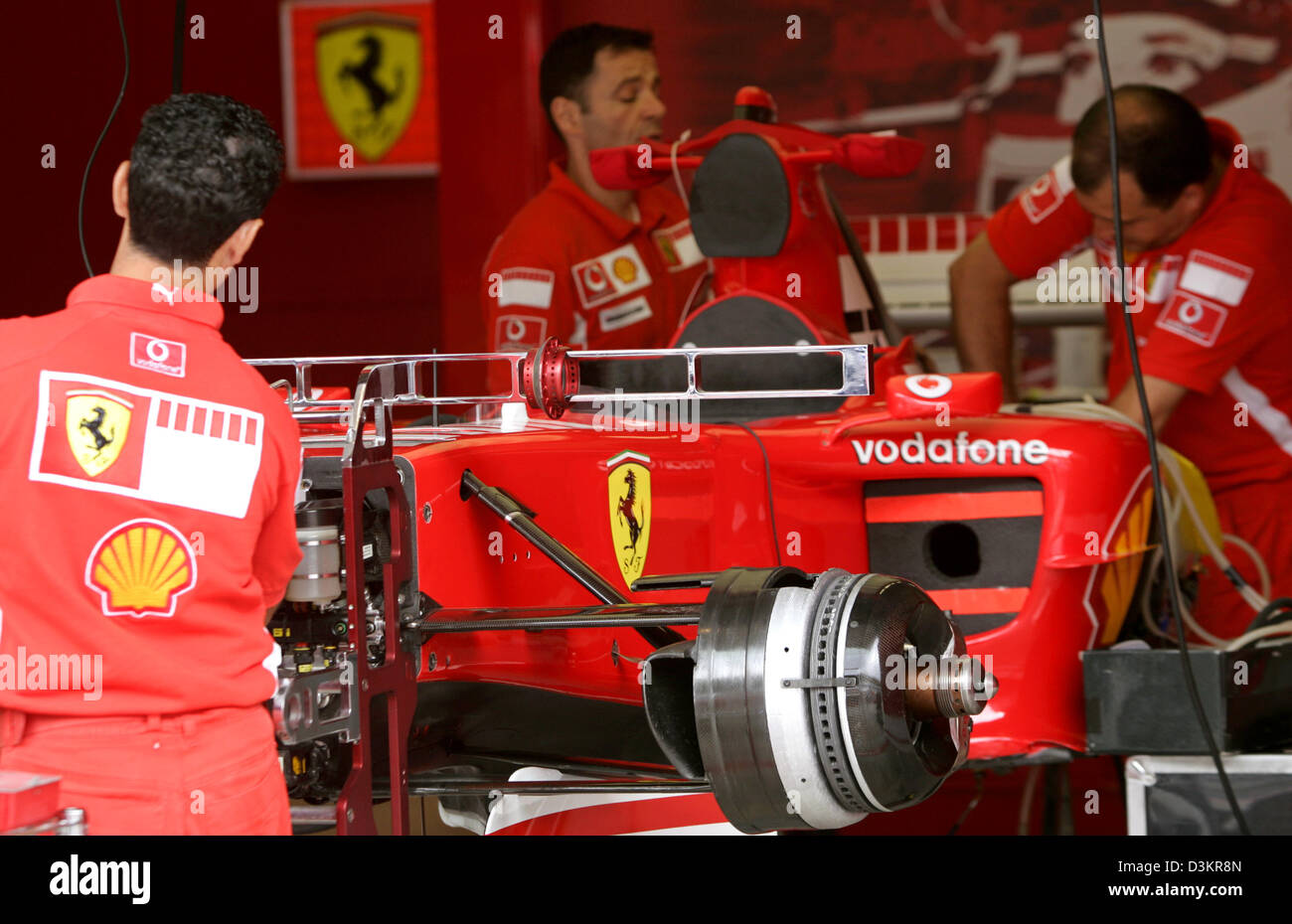 (dpa) - Mechanics of Ferrari work in the pit of their racing team at ...